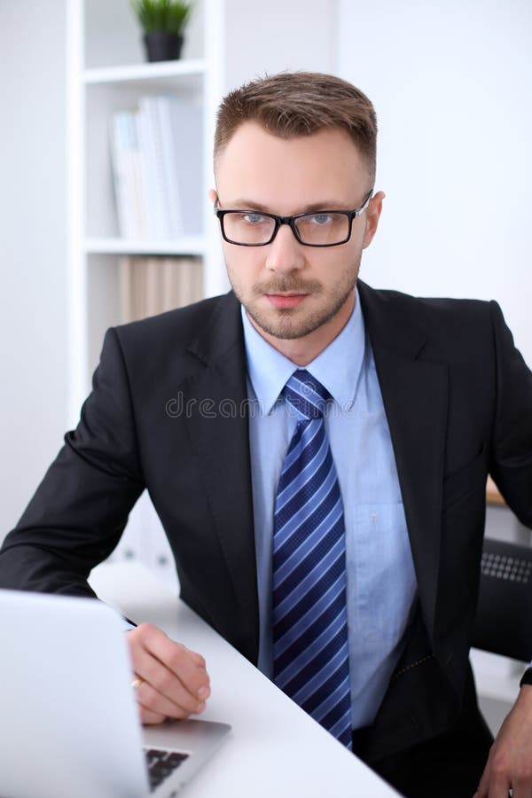 Portrait of Businessman Sitting at the Desk in Office Workplace Stock ...