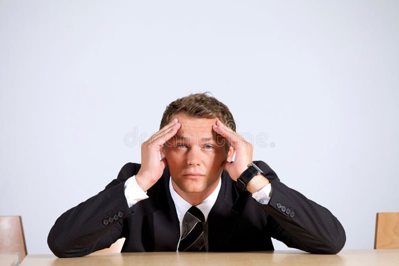 Portrait of Businessman Sitting with Head in Hands in Office Stock ...