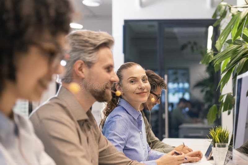 Portrait of Call Center Worker Accompanied by Her Team. Smiling ...