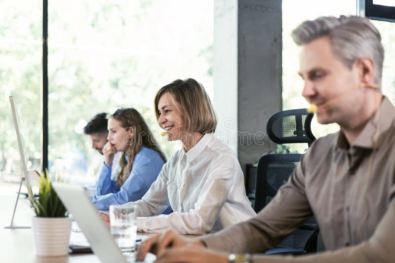 Portrait of Call Center Worker Accompanied by Her Team. Smiling ...