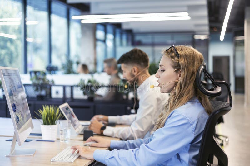 Portrait of Call Center Worker Accompanied by Her Team. Smiling ...