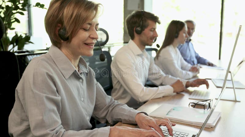 Portrait of Call Center Worker Accompanied by Her Team. Smiling ...