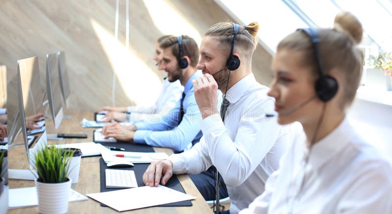 Portrait of Call Center Worker Accompanied by His Team. Smiling ...