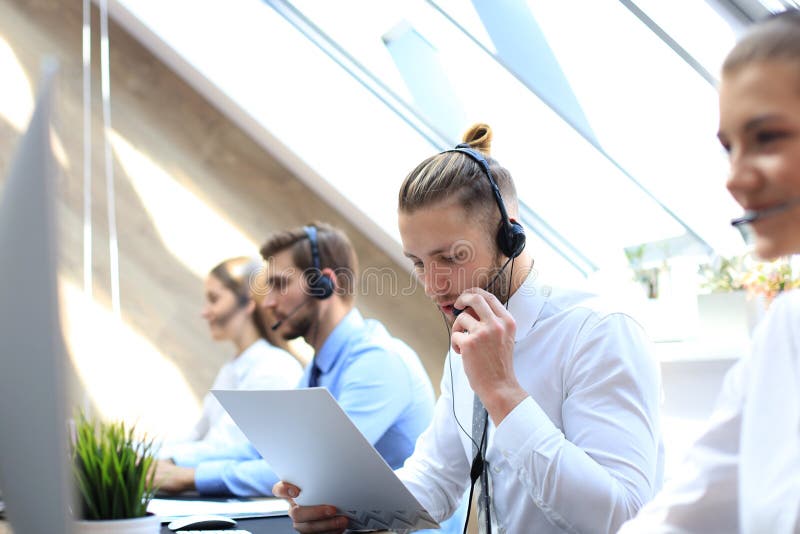 Portrait of Call Center Worker Accompanied by His Team. Smiling ...