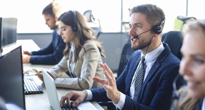 Portrait of Call Center Worker Accompanied by His Team. Smiling ...