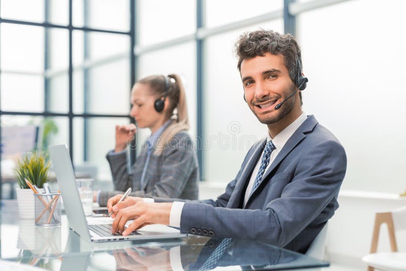 Portrait of Call Center Worker Accompanied by His Team. Smiling ...