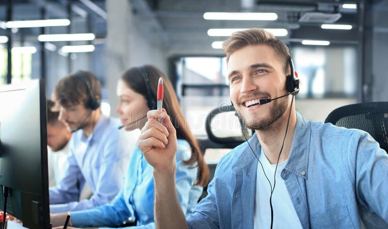 Portrait of Call Center Worker Accompanied by His Team. Smiling ...