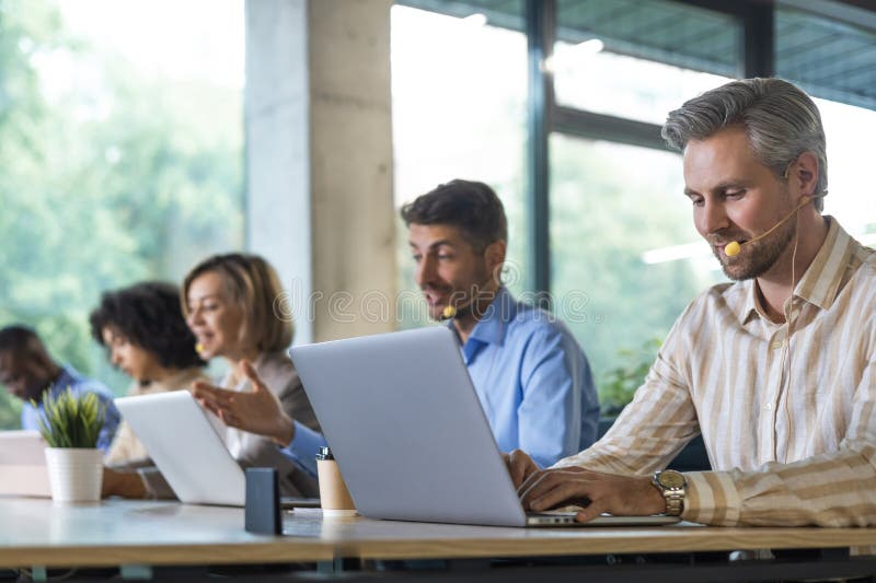 Portrait of Call Center Worker Accompanied by His Team. Smiling ...