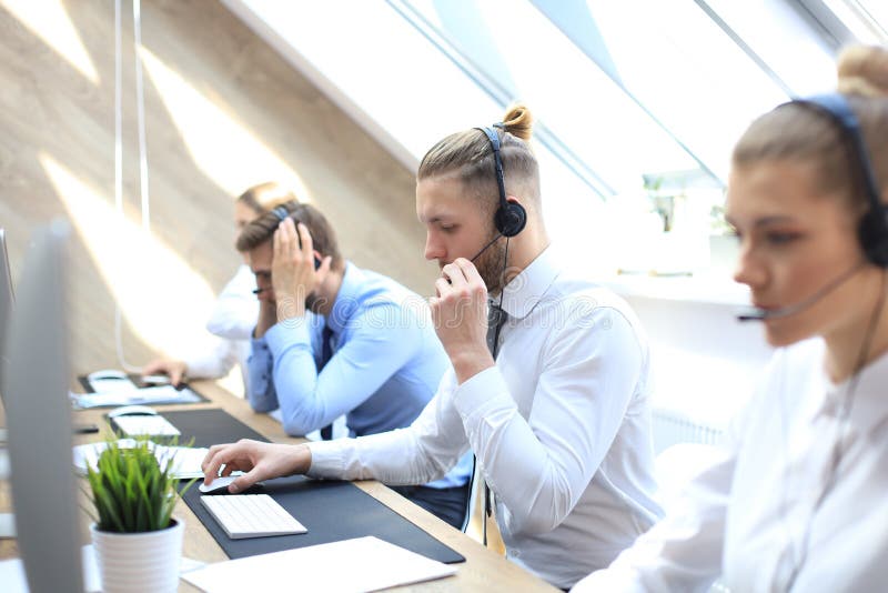 Portrait of Call Center Worker Accompanied by His Team. Smiling ...
