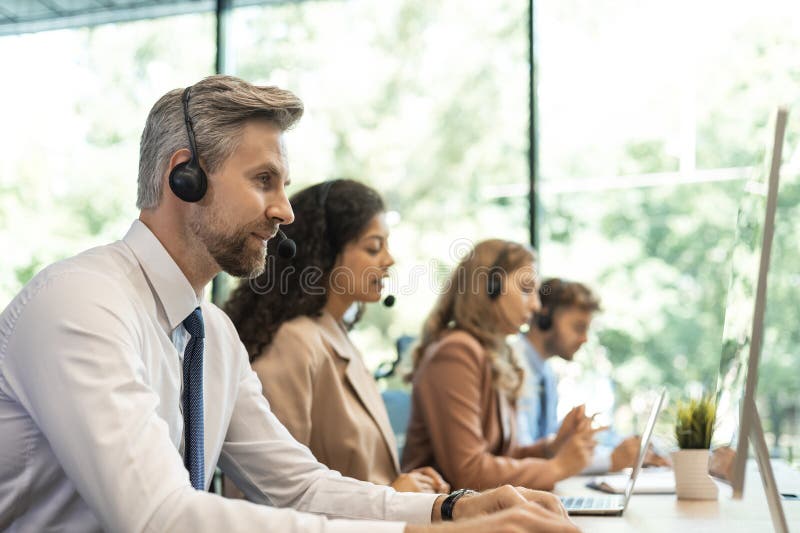 Portrait of Call Center Worker Accompanied by His Team. Smiling ...
