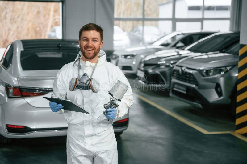 Portrait of Car Painter that is Standing in the Garage with Documents ...