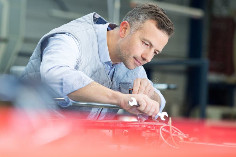 Portrait Casual Man Fixing Something Stock Photo - Image of ...