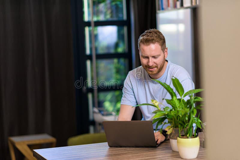 Portrait of Casual Pensive Puzzled Man Using Computer Looking at Laptop ...