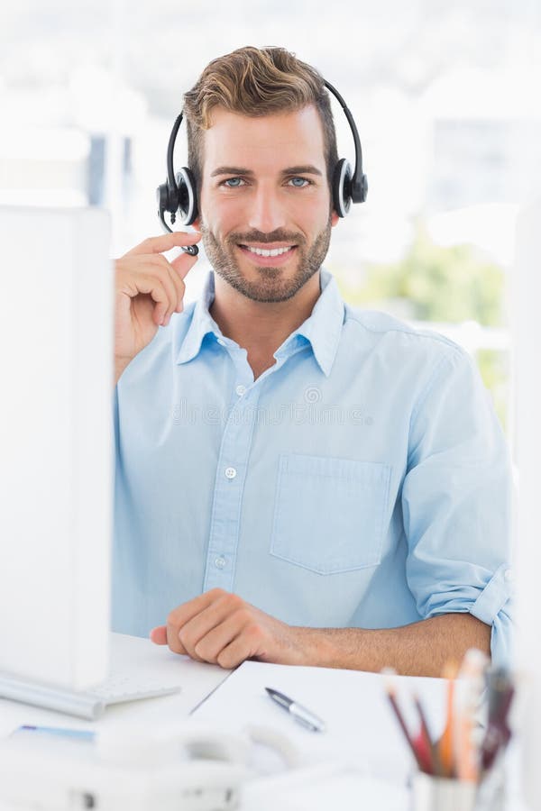 Portrait of a Casual Young Man with Headset Using Computer Stock Photo ...