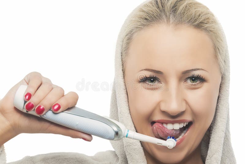 Portrait Of Caucasian Blond Woman In Bathrobe Cleaning Teeth Wit Stock