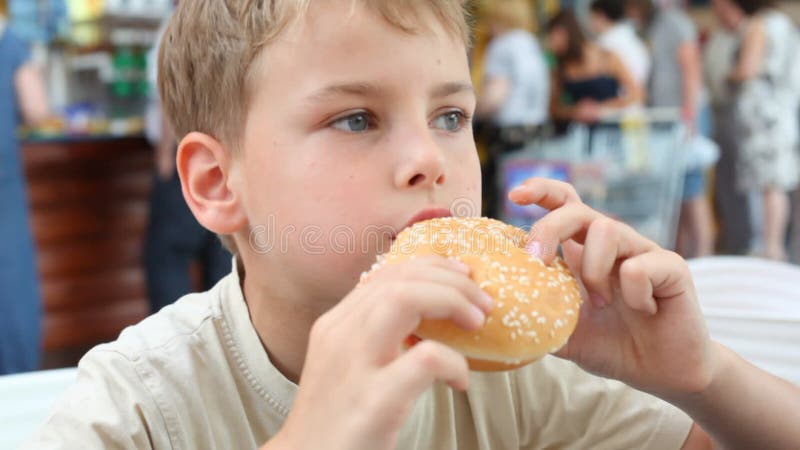 Portrait of Caucasian Boy Eating Hamburger in Stock Video - Video of ...