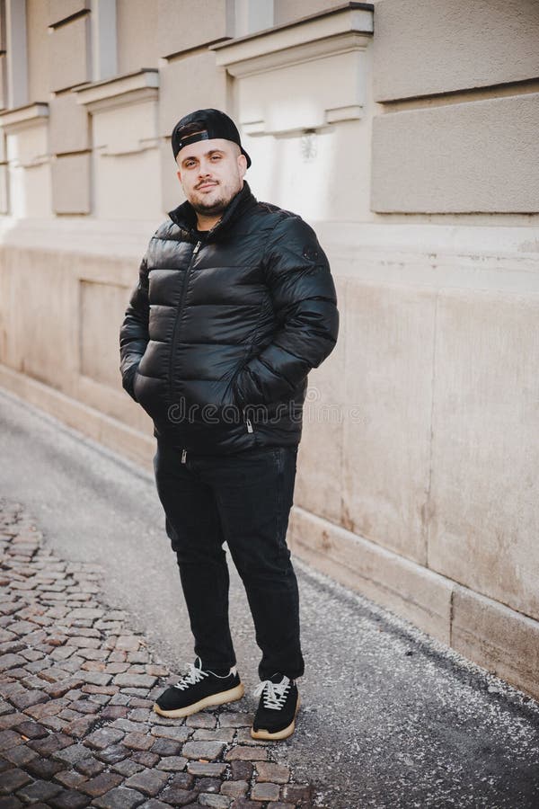 Portrait of a Caucasian Man with a Puffer Jacket and a Cap Posing ...