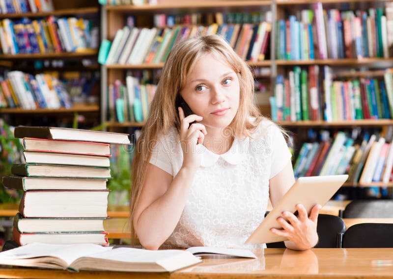 Portrait of a Caucasian Teen Girl in Library Using Tablet Computer ...