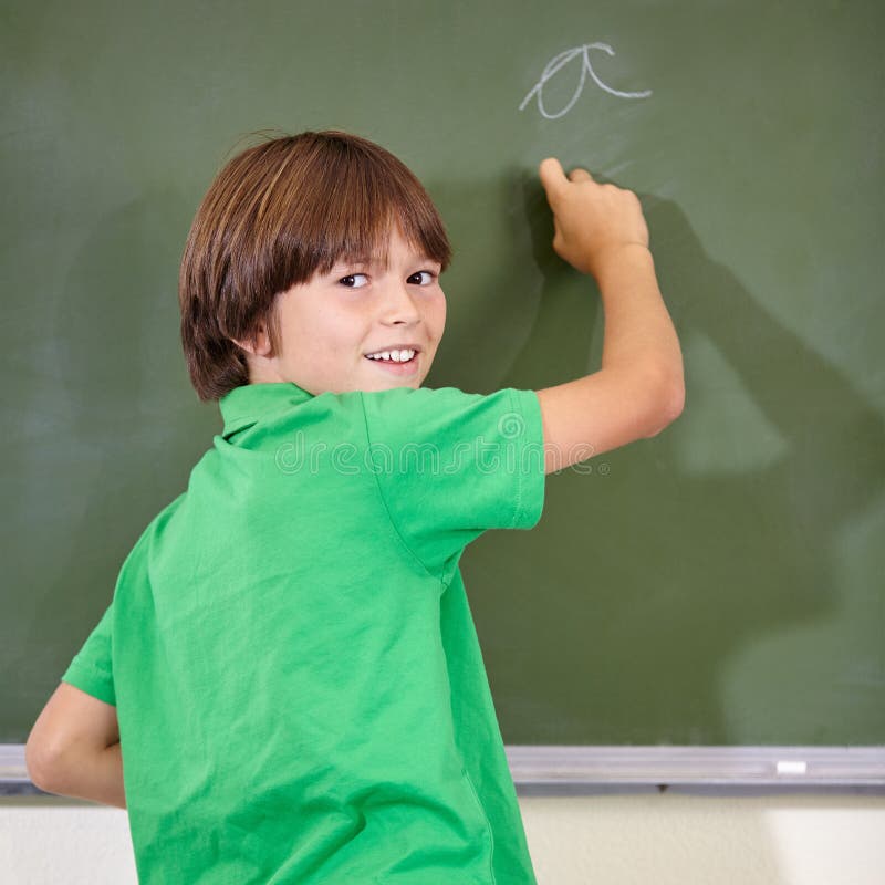 The Best Way To Learn. a Young Boy Writing on the Blackboard at School ...