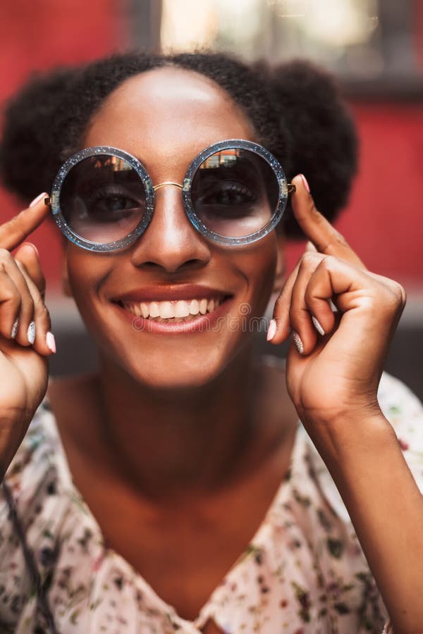 Portrait Of Cheerful African Girl With Dark Curly Hair In Sunglasses