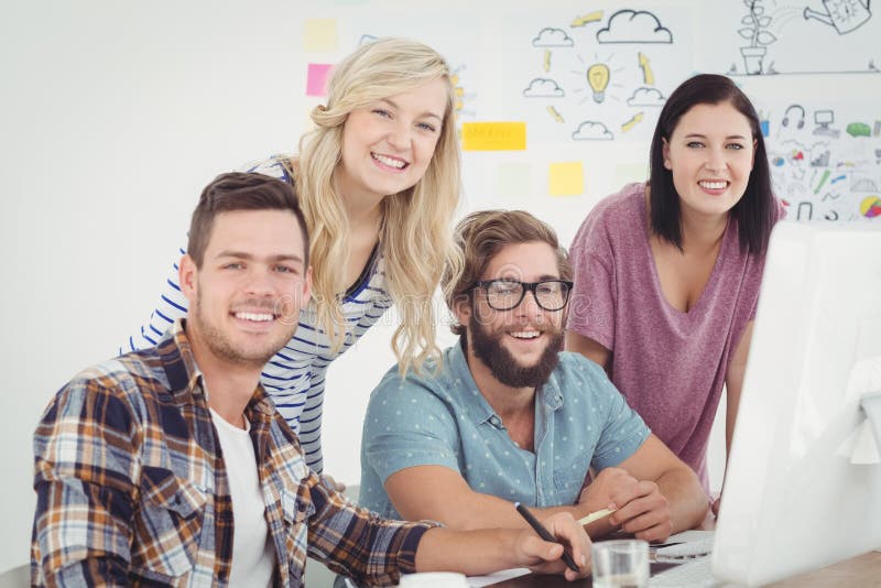 Portrait of Cheerful Business Professionals Working at Computer Desk ...