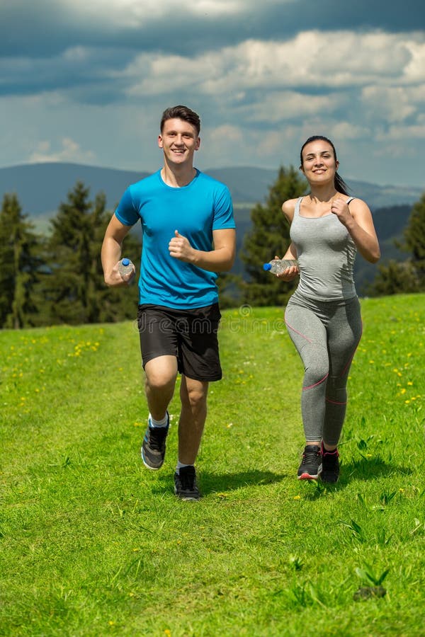 Portrait of Cheerful Caucasian Couple Running Outdoors Stock Photo ...
