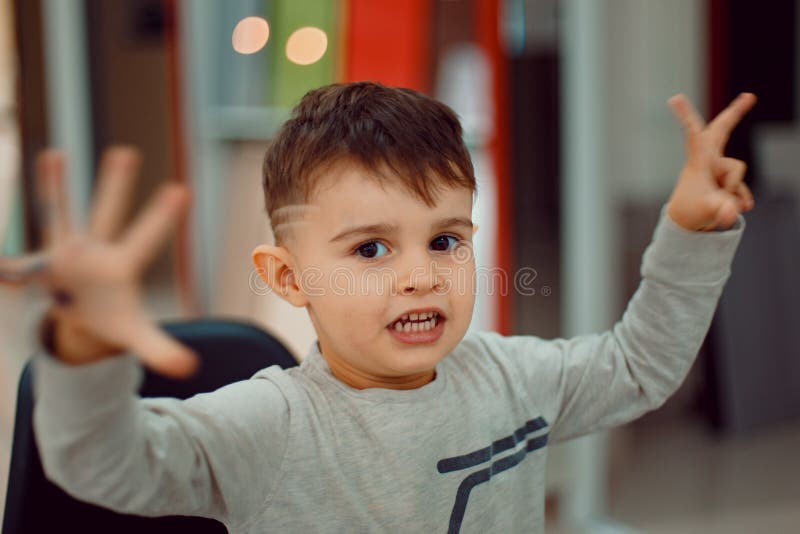 Portrait of a Cheerful Child Smiling Showing Something on the Camera ...