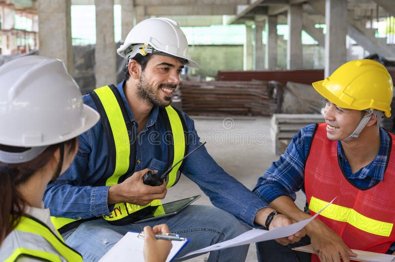 Portrait of a Cheerful Engineering Man while Having Project Solution Discussion with Teamwork ...