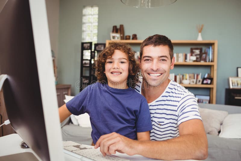 Portrait of Cheerful Father and Son Using Computer Stock Photo - Image ...