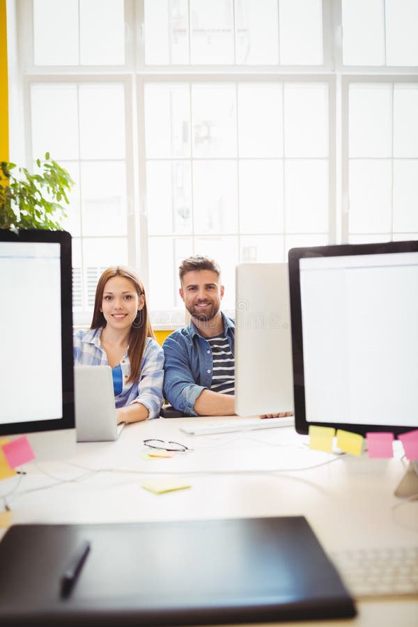 Portrait of Cheerful Graphic Designers Sitting at Desk Stock Image ...