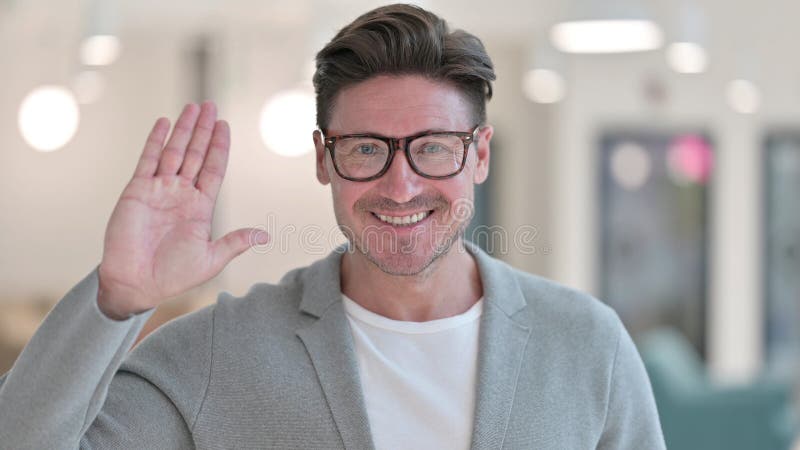 Portrait of Cheerful Middle Aged Man Waving at the Camera Stock Photo ...