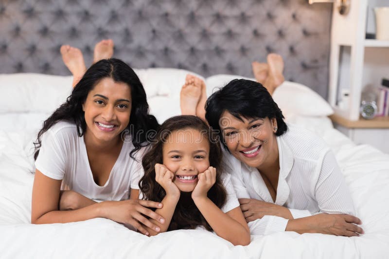 Portrait of Cheerful Multi-generation Family Lying on Bed Stock Photo ...
