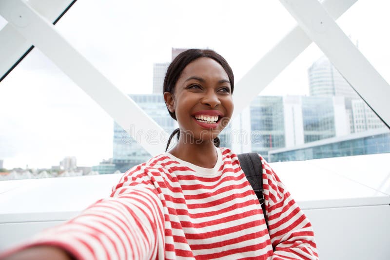 Cheerful Young African American Woman Taking Selfie In The City Stock