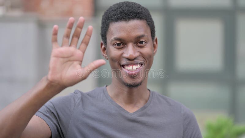 Portrait of Cheerful Young African Man Waving, Hello Stock Photo ...