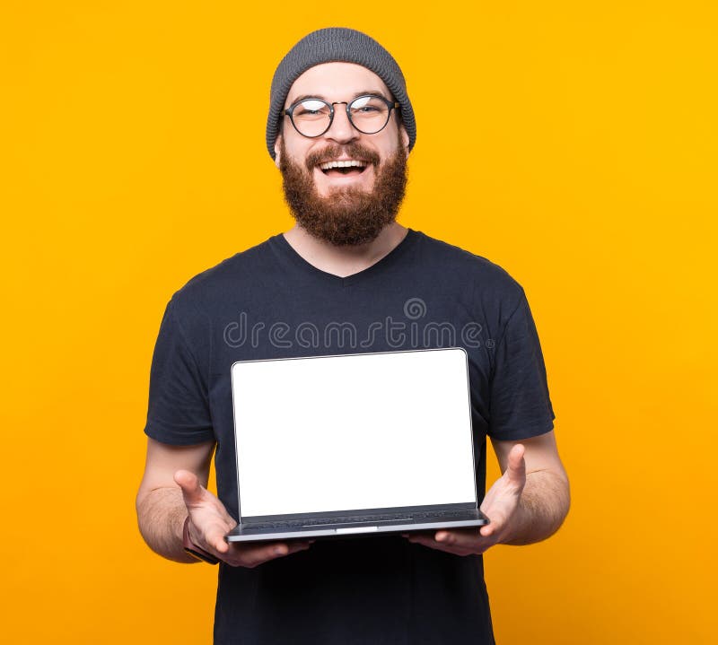 Portrait of Cheerful Young Man with Beard Holding Laptop with White ...
