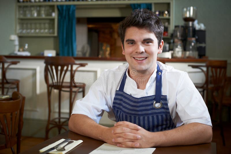 Portrait of Chef Sitting at Table in Restaurant Stock Photo - Image of ...