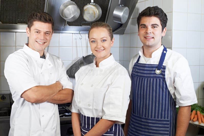 Portrait of Chef and Staff Standing by Cooker in Kitchen Stock Image ...
