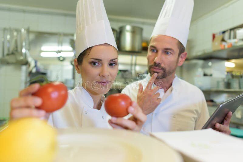 Man and Woman Chefs Cooking Food at Restaurants Kitchen Stock Photo ...