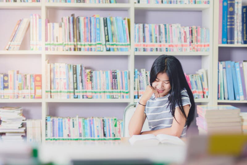Portrait of Clever Asian Student Reading and Doing Research in C Stock ...
