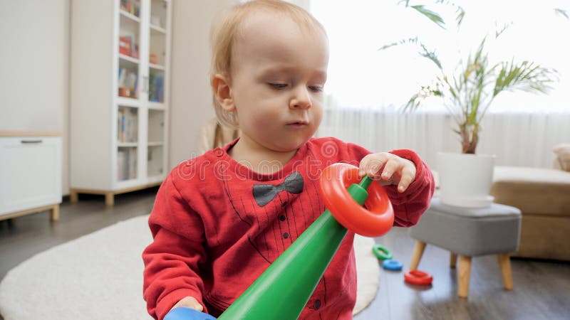Portrait of Concentrated Baby Boy Assembling Toy Tower or Pyramid ...
