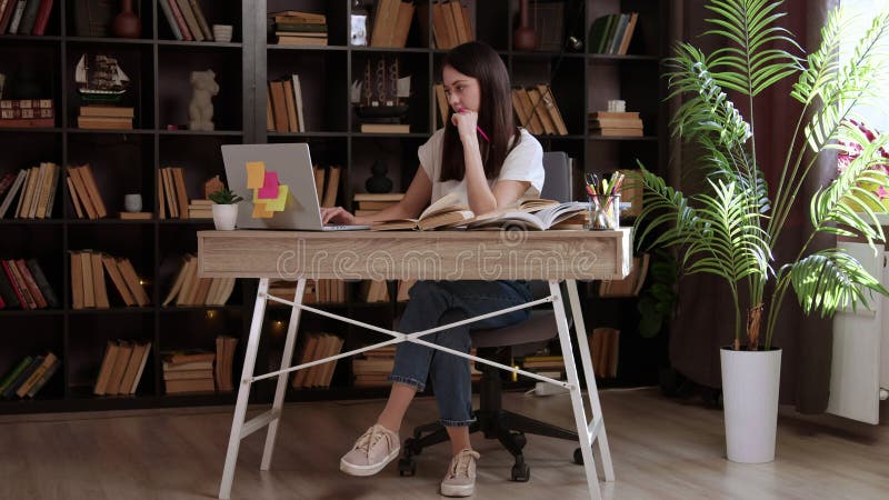 Portrait of a Concentrated Female Student Writing Notes from Books ...