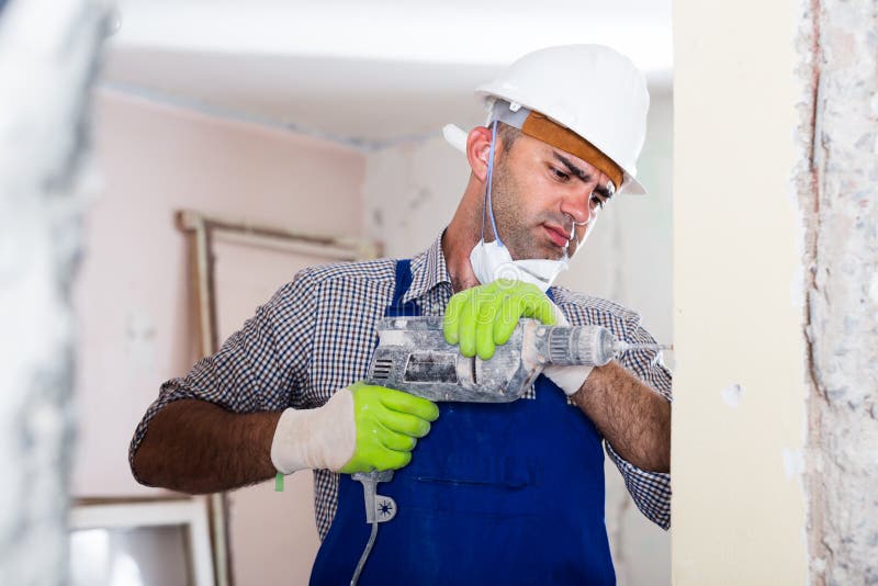 Portrait of Concentrated Repairer Man Standing with Drill Indoors Stock ...