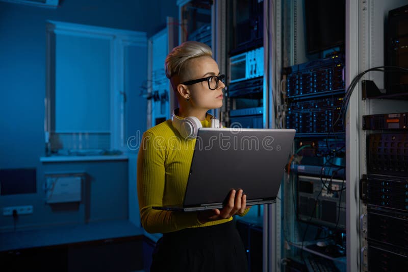 Portrait Of Concentrated Woman Coder Solving Problem In Data Center