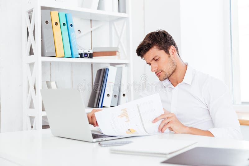 Portrait of a Concentrated Young Businessman Looking at Documents Stock ...
