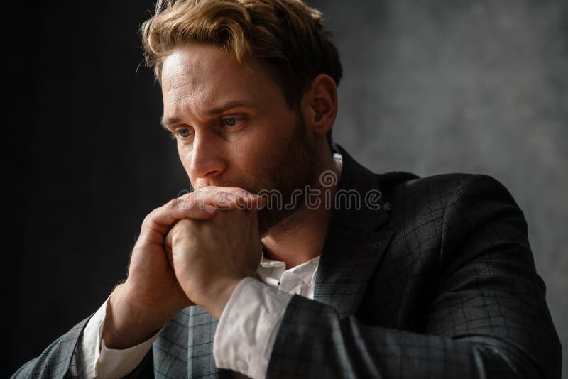 The Portrait of a Concentrating Man in a Jacket in the Studio Stock ...
