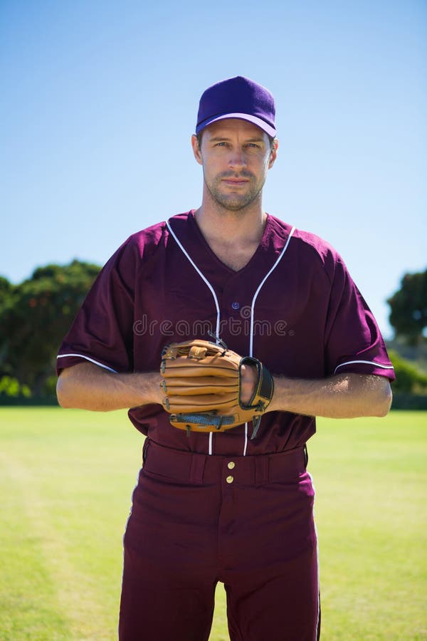 Portrait of Confident Baseball Pitcher Standing Against Sky Stock Photo ...