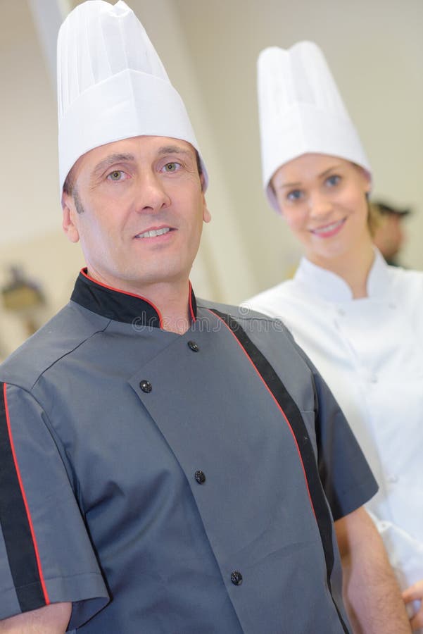 Portrait Confident Female and Male Chef in Kitchen Stock Image - Image ...