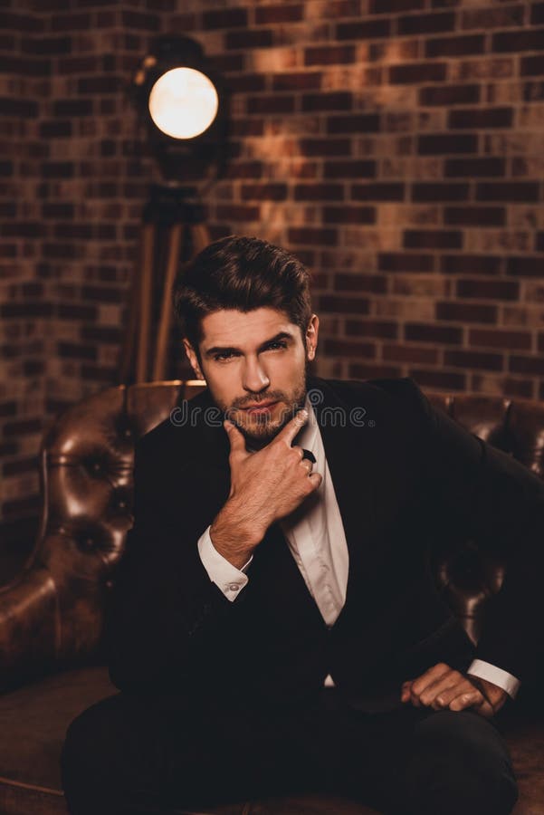 Portrait of Confident Harsh Man in Black Suit Sitting on Sofa Stock ...