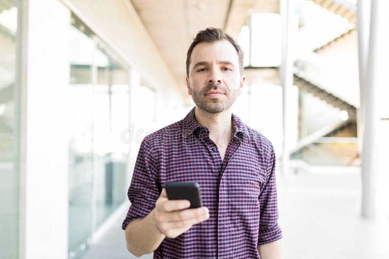 Man Browsing Internet on Mobile Phone in Shopping Mall Stock Image ...