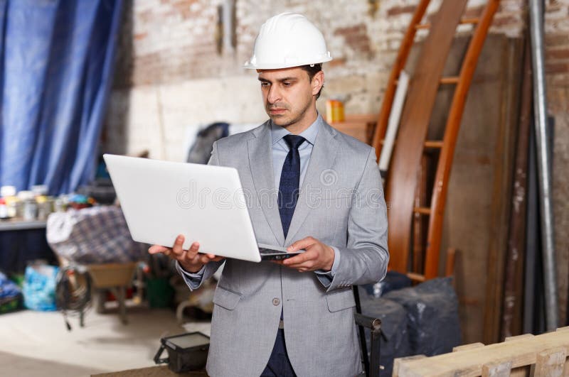 Manager Using Laptop with Blueprints Stock Image - Image of inside ...